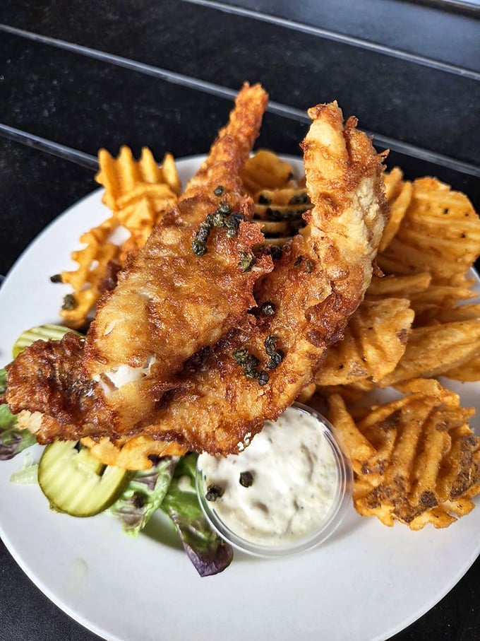Golden-battered fish so crispy you can hear the crunch from three tables away, served with waffle fries that refuse to be mere sidekicks.