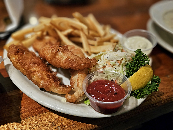 Golden-battered fish that shatters with each bite, paired with fries that could make a Frenchman weep. The coleslaw's just showing off at this point.