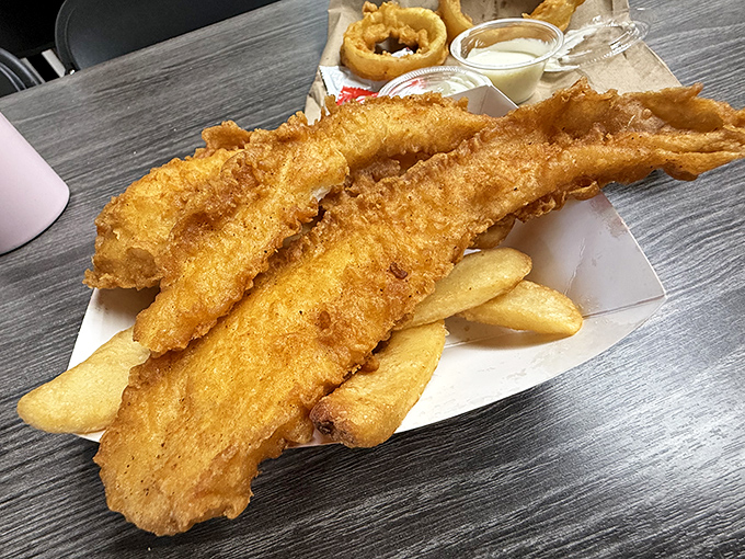 Golden, crispy perfection that makes you wonder if the batter contains some kind of addictive substance. The fish practically shatters when your fork touches it.