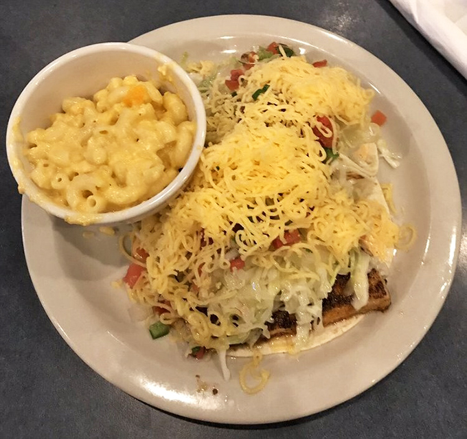 These fish tacos aren't just a meal; they're an event—complete with a side of mac and cheese that would make your childhood self high-five your adult self.