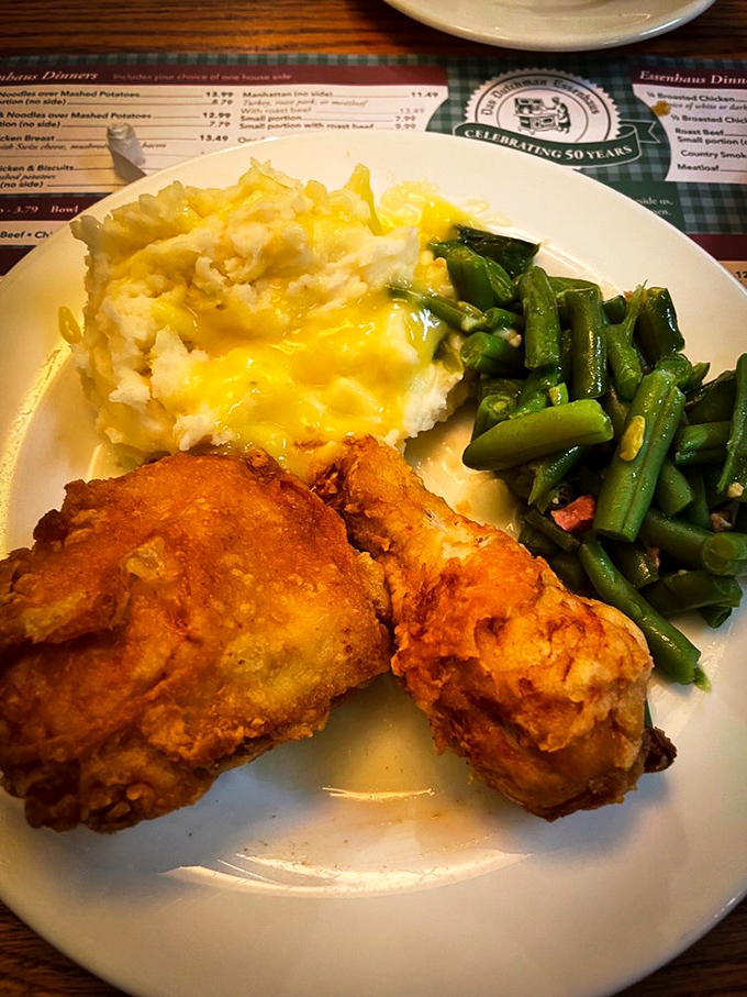 Golden-brown fried chicken that crackles with each bite, paired with cloud-like mashed potatoes and green beans. This is what food dreams are made of.