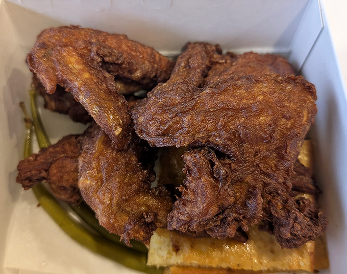 This isn't just fried chicken &ndash; it's edible artwork with a PhD in crispiness. The kind of golden-brown perfection that makes you momentarily forget your table manners.