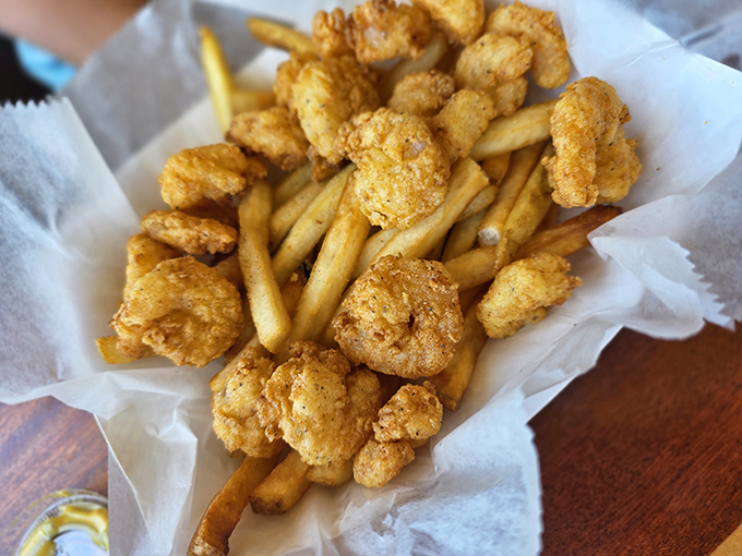Golden-fried shrimp nestled among crispy fries—a beach day classic that makes you wonder why you'd ever eat seafood anywhere else.