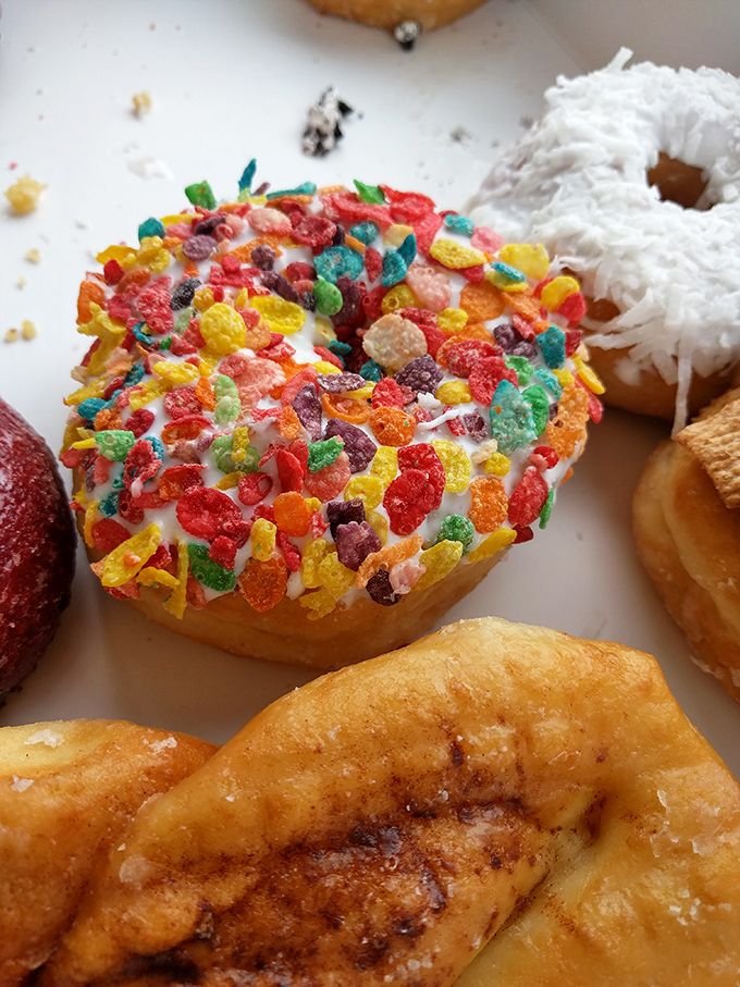 Childhood cereal memories transformed into adult indulgence. This Fruity Pebbles donut brings Saturday morning cartoon vibes to your coffee break.