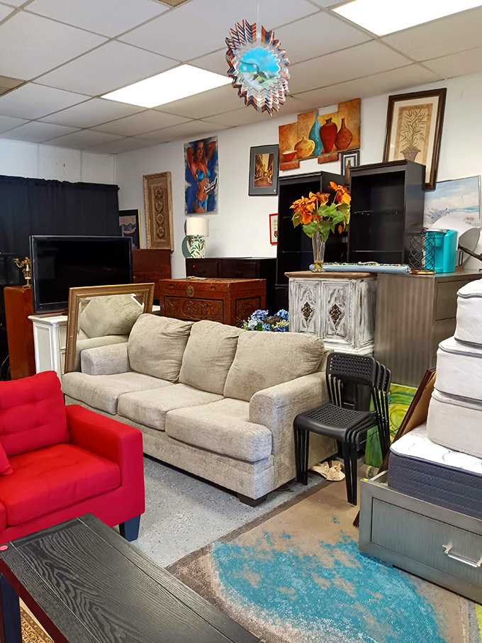 Living room vignettes create instant "I could see this in my house" moments, with that pop of red chair adding just the right amount of drama.