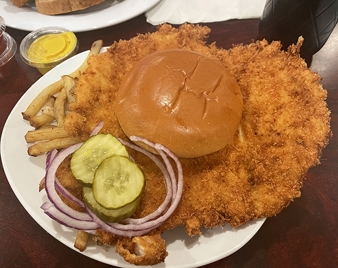 Behold the legendary tenderloin&mdash;a golden-fried masterpiece that makes the bun look like it's wearing a meat hula skirt.