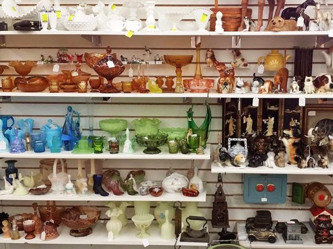 Shelves of colorful glassware create a rainbow that would make Dorothy skip the yellow brick road.