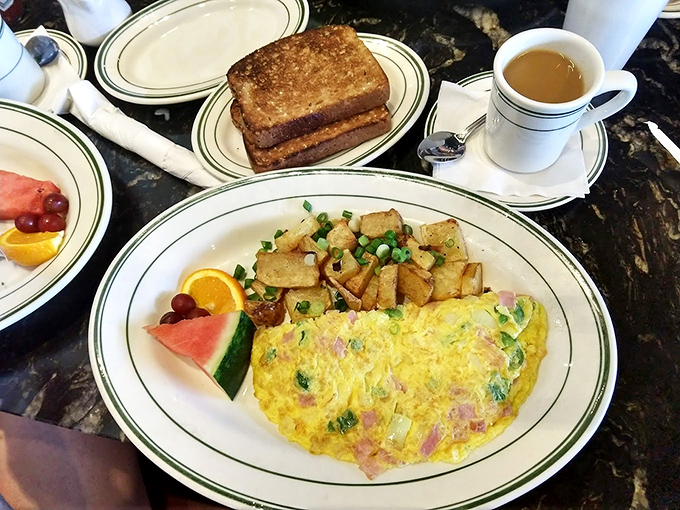 Behold the Western omelet in all its glory&mdash;fluffy eggs embracing ham and veggies with home fries standing guard. Breakfast perfection exists!