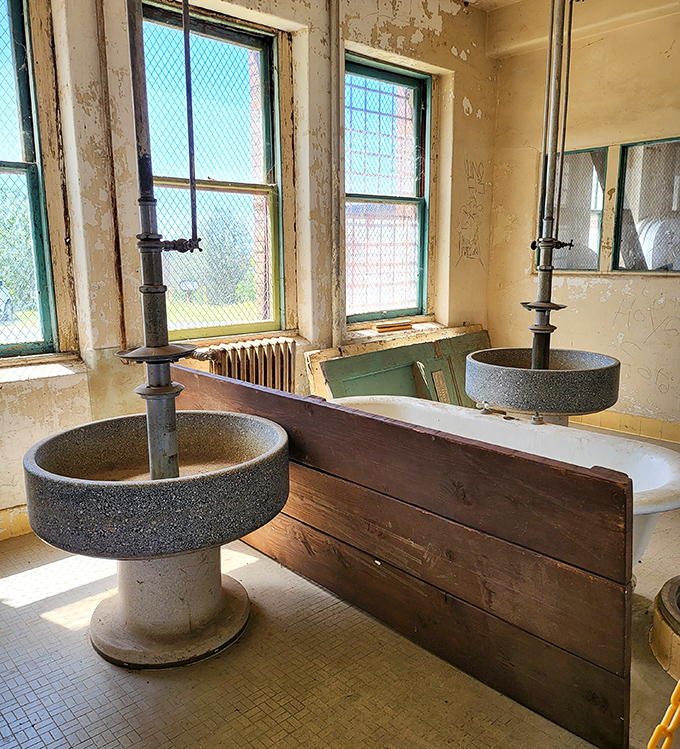 These stone basins have witnessed thousands of morning routines. Imagine the complaints about cold water echoing off these institutional walls!