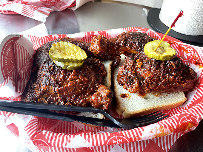 Dark, glistening, and unapologetically spicy&mdash;this chicken doesn't just satisfy hunger, it creates memories. Those pickle chips aren't garnish; they're essential fire extinguishers.