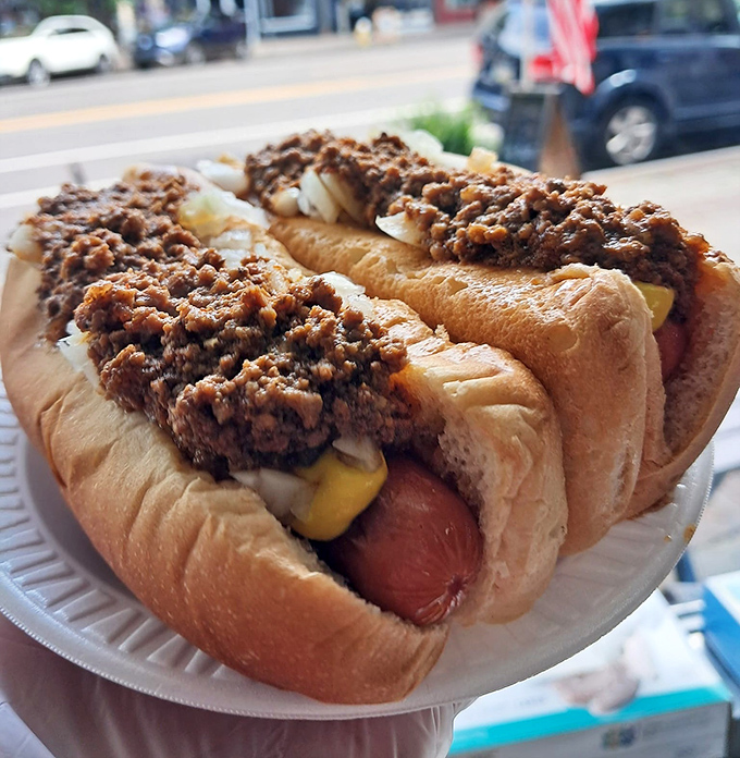 These chili dogs aren't just topped&mdash;they're smothered with love. The kind of messy perfection that makes napkins essential and regrets impossible.