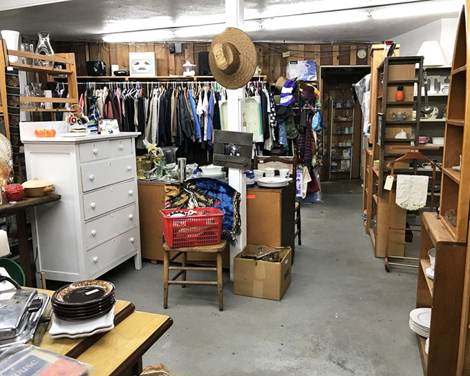 The organized chaos of a true collector's paradise &ndash; white dresser meets vintage clothing with a straw hat standing sentinel above.