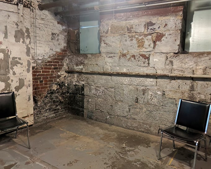 What stories these peeling walls could tell! The interrogation room's stark simplicity&mdash;just two chairs facing off&mdash;speaks volumes about power dynamics in criminal justice history.