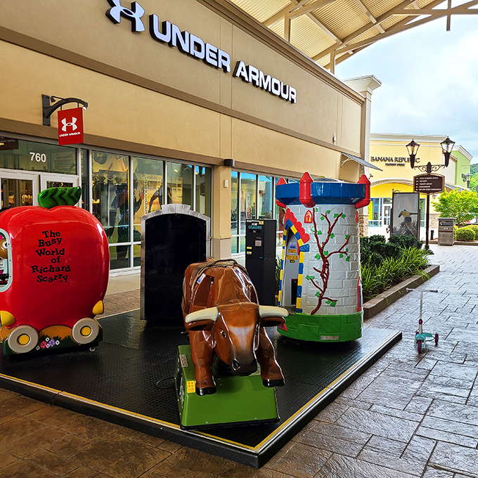 Whimsical kiddie rides outside Under Armour provide entertainment for tiny shoppers while parents browse performance wear.