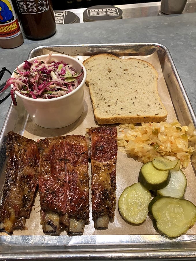 These ribs don't just fall off the bone&mdash;they practically leap into your mouth, accompanied by their faithful sidekicks: slaw, kraut, and pickles.