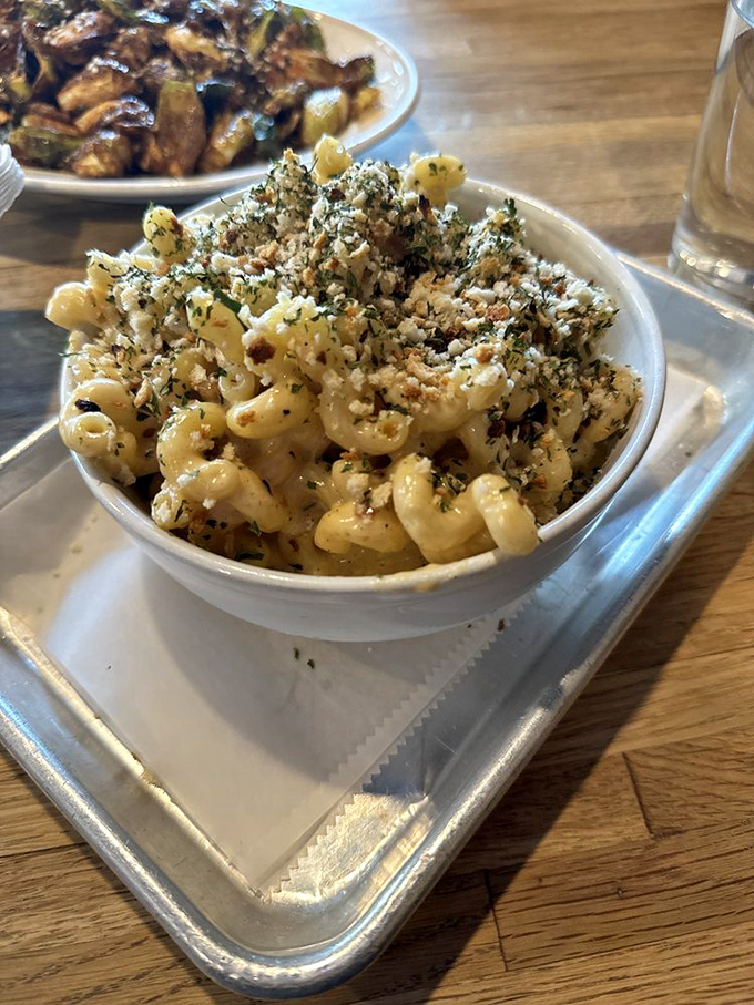 Mac and cheese that's dressed for success with herbs and breadcrumbs. Comfort food that went to finishing school and came back with a doctorate in deliciousness.
