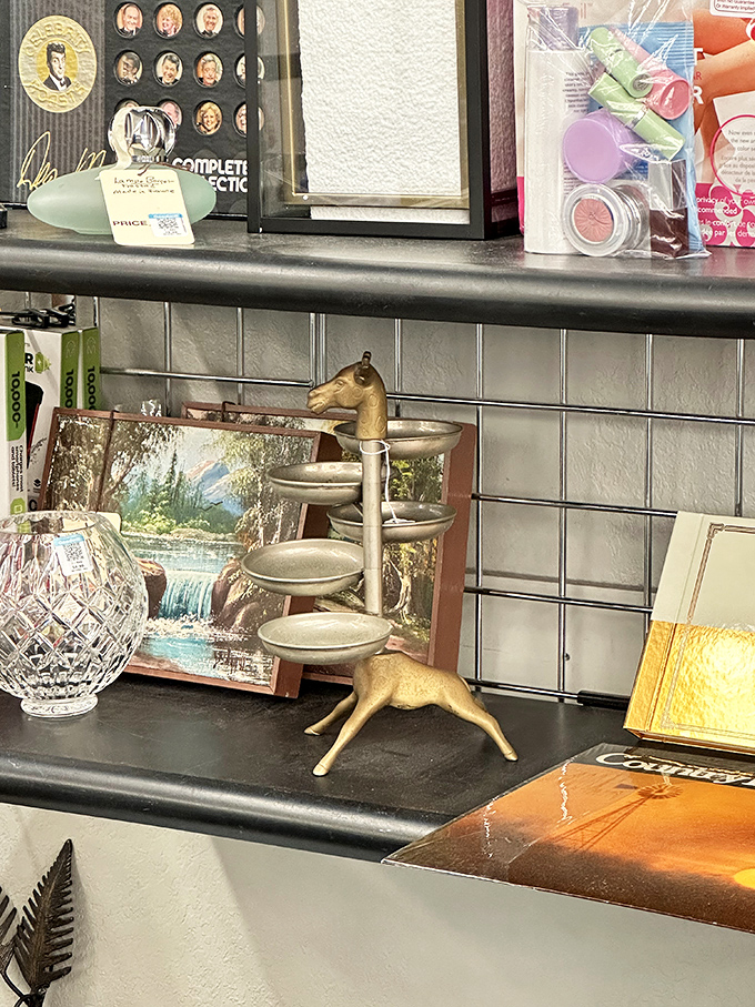 Brass deer and crystal treasures stand at attention. One shopper's decluttered mantel becomes another's conversation piece in this curated corner.