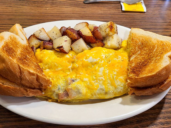 Golden perfection on a plate. This cheese-laden omelet practically whispers "good morning" with every bite of melty, savory goodness.