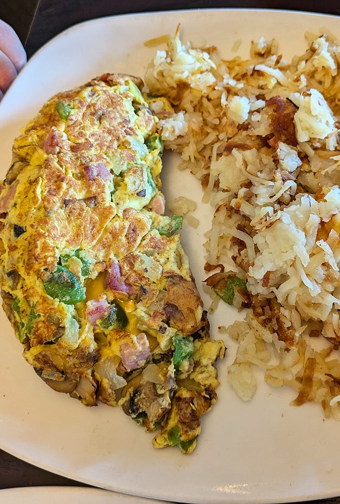 This isn't just an omelet&mdash;it's a masterclass in egg architecture. Perfectly folded around fresh vegetables with hash browns that achieved the crispy-fluffy golden ratio.