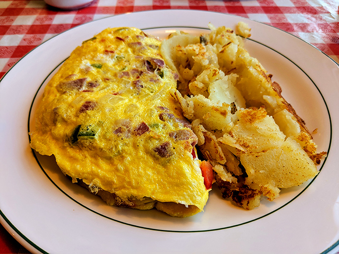 This omelet has clearly been to college—it's well-rounded, full of potential, and paired with those home fries that deserve their own fan club.