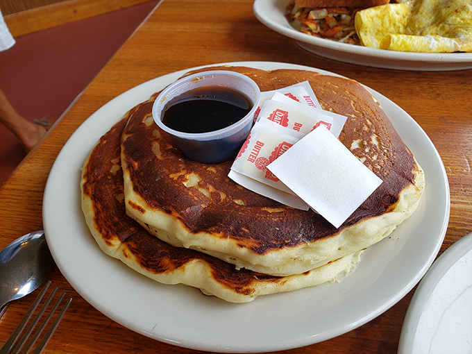 These aren't just pancakes; they're golden discs of happiness with the perfect crispy edge-to-fluffy-center ratio that would make your grandmother proud.