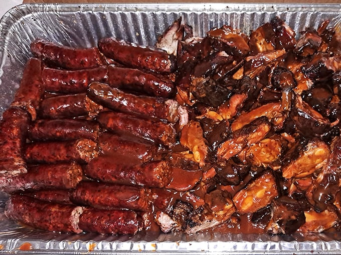 Behold the holy grail of Chicago BBQ: links and tips sharing a foil container like old friends, glistening with sauce that demands respect.