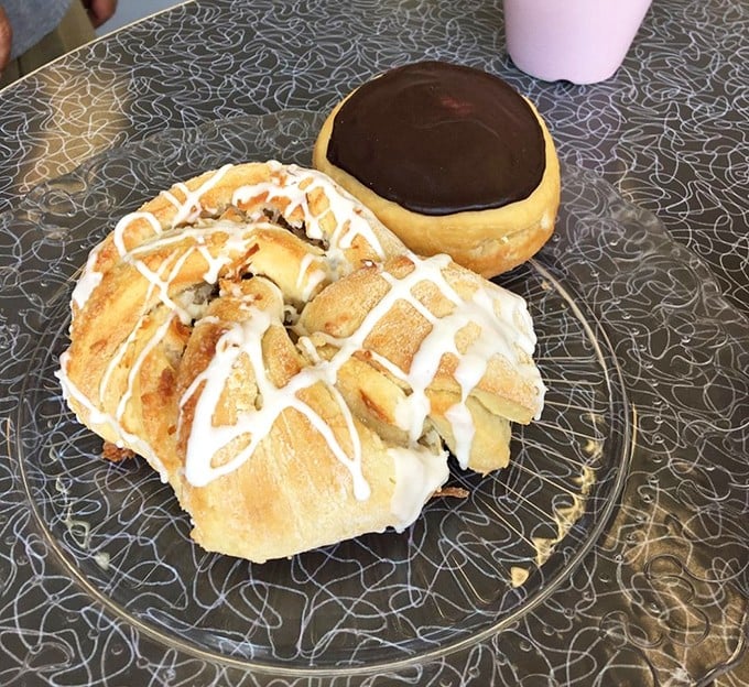 Two perfect specimens of vegan artistry—one drizzled with icing, one crowned with chocolate. No animals were harmed in the making of this joy.