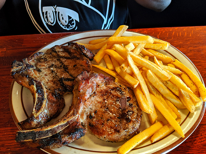 These pork chops have more sizzle than a Florida summer, paired with golden fries that could make a potato farmer weep with joy.