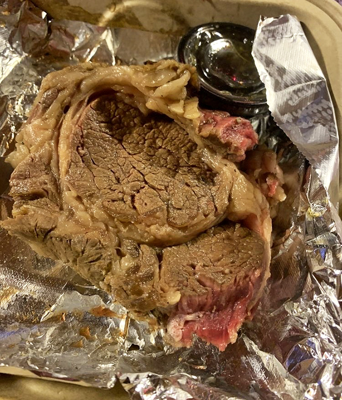 This prime rib isn't just cooked&mdash;it's been on a slow, patient journey to perfection. The foil-wrapped package reveals its beefy treasure like a carnivore's Christmas morning.