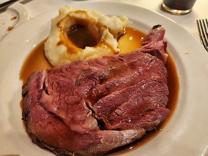 This, friends, is what perfection looks like: prime rib so tender it practically surrenders to your fork, nestled beside a cloud of mashed potatoes.