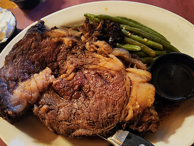 Behold the star of the show! Prime rib that doesn't need Instagram filters, served with green beans that actually taste like vegetables should.