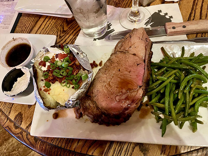 A prime rib cooked to pink perfection, accompanied by a loaded baked potato and green beans&mdash;the cowboy's reward after a long day.