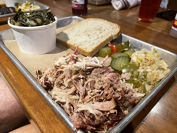 Pulled pork so tender it practically pulled itself. Served with the holy trinity of BBQ sides: pickles, slaw, and bread.