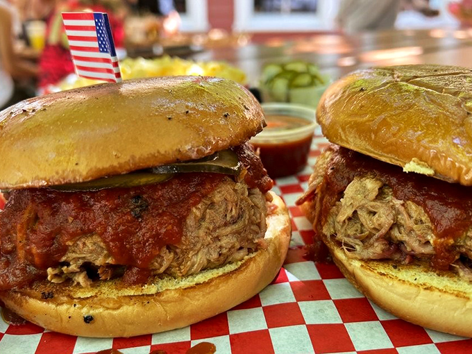 Two pulled pork sandwiches that make you understand why people have barbecue pilgrimages. That tiny American flag is standing proud.