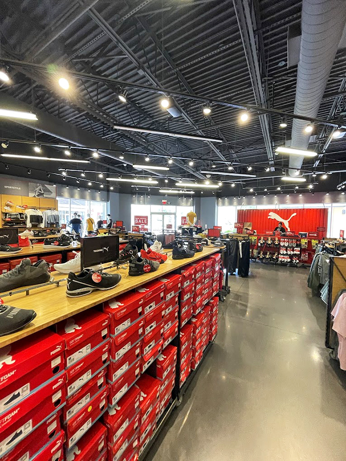 Sneaker heaven awaits at Puma, where rows of red boxes hold footwear dreams and the promise of walking comfortably through miles of outlet aisles.