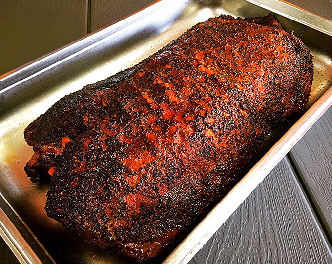 Behold the brisket in all its glory – a bark so perfect it could make a tree jealous, with a smoke ring that tells tales of patience.