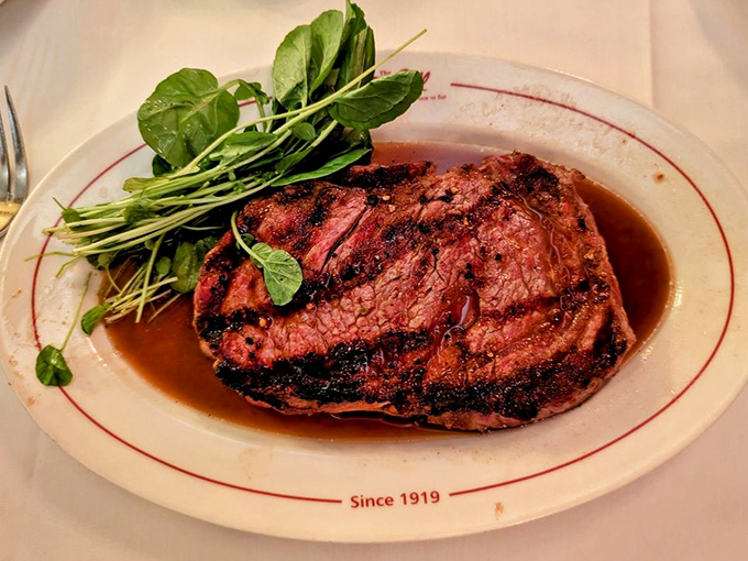 The legendary rib eye steak, perfectly charred and glistening. One bite explains why this dish has been drawing crowds since Calvin Coolidge was president.