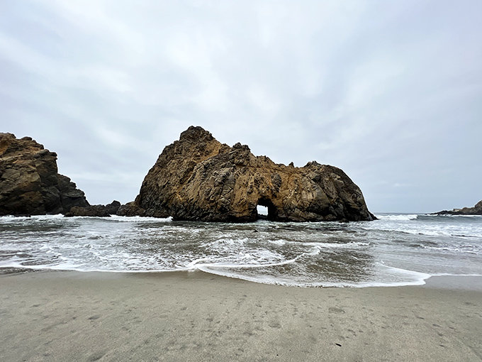 The famous Keyhole Rock stands sentinel in the surf, nature's perfect picture frame waiting for sunset to work its golden magic.