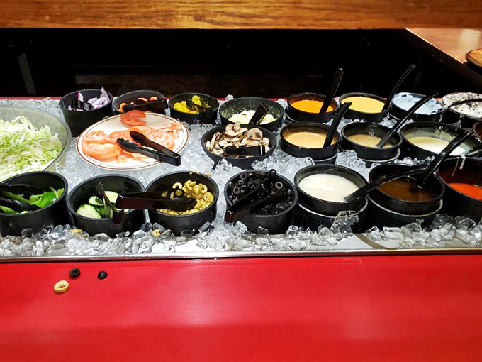 The salad bar's colorful array of toppings sits chilled on ice – proof that vegetables can indeed be exciting when they're this fresh.