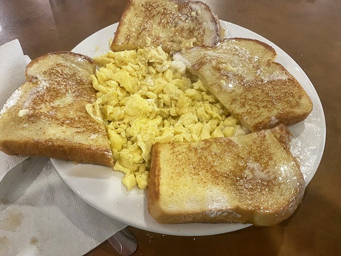 Golden toast surrounds fluffy scrambled eggs like edible picture frames, proving that breakfast artistry doesn't require fancy culinary school credentials.