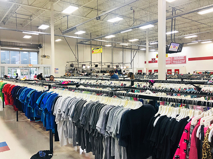 Color-coded shirts stand at attention like soldiers in a rainbow army, each waiting for their chance at a second life.