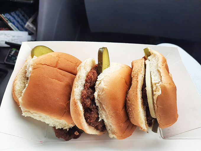 Three perfect sliders lined up like edible time machines. Each one transports you back to when food was honest and pickle placement was an art form.