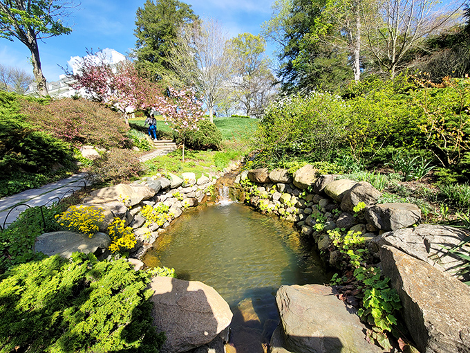 Serenity in stone and water. This tranquil pond creates a moment of reflection, literally and figuratively, amid the park's artistic wonders.