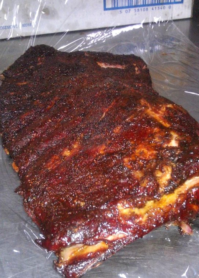 These spare ribs aren't just cooked&mdash;they're transformed into glistening, spice-crusted monuments to patience and fire.