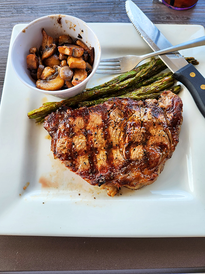 This isn't just a steak&mdash;it's a masterpiece of meat, perfectly seared and accompanied by grilled asparagus and saut&eacute;ed mushrooms that could steal the show on their own.