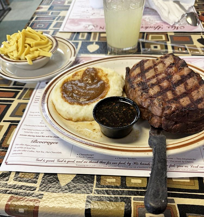 Behold the star attraction: a perfectly grilled steak alongside mashed potatoes with gravy pools so good you'll want to dive in headfirst.