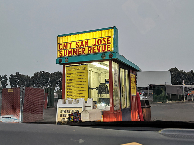 A splash of neon nostalgia! This ticket booth isn't just selling admission&mdash;it's offering a time machine to when entertainment was gloriously communal.