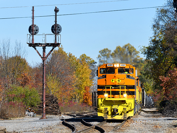 A bright yellow locomotive chugs along tracks near Mount Jewett, a colorful reminder of the region's rich railroad heritage.