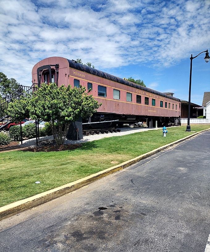 The restored Pullman car gleams in the Tennessee sunshine, a burgundy beauty that once carried passengers in a style modern travel can only dream about.