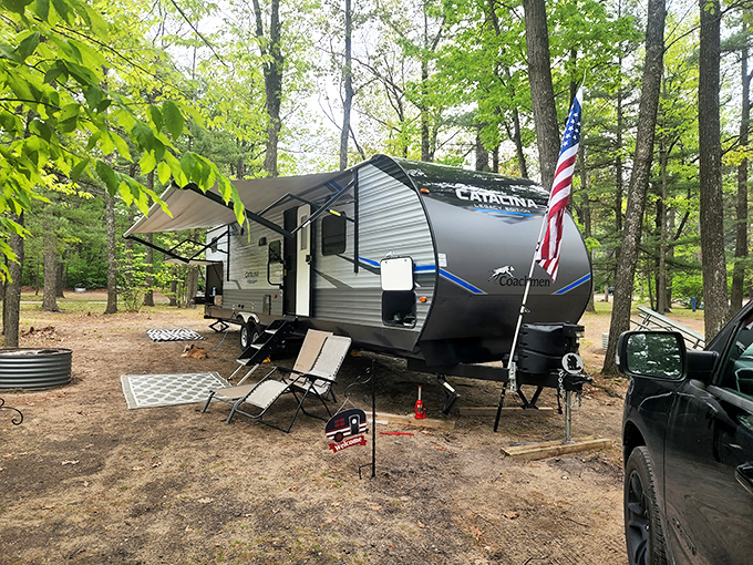 Home away from home, where camping meets comfort. The American flag says "vacation" but the trees whisper "wilderness."